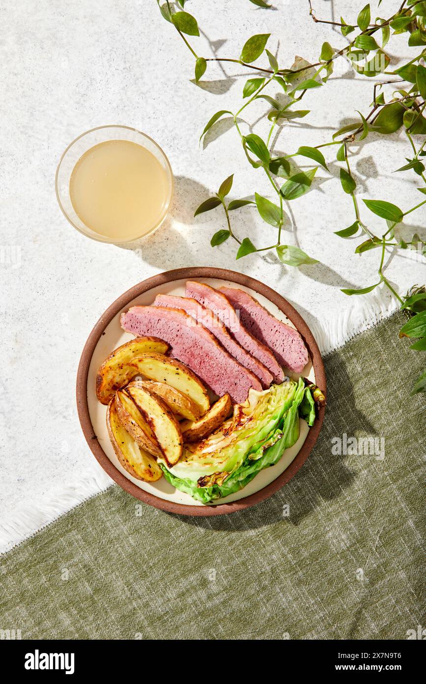 Corned Beef, Roasted Potatoes and Cabbage Meal on a green and white ...