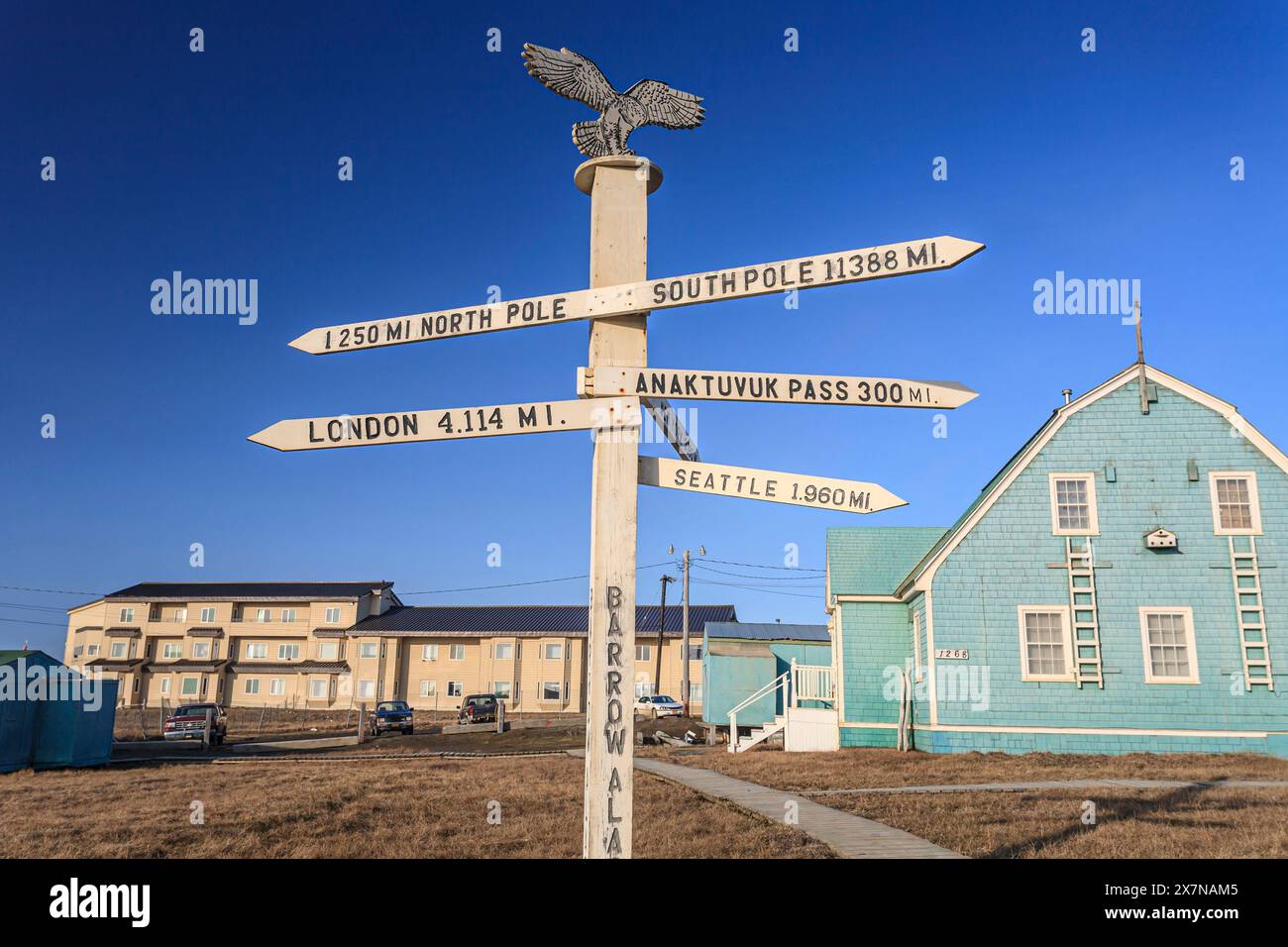 Distance sign in front of old wooden house, Barrow, Alaska, USA Stock ...