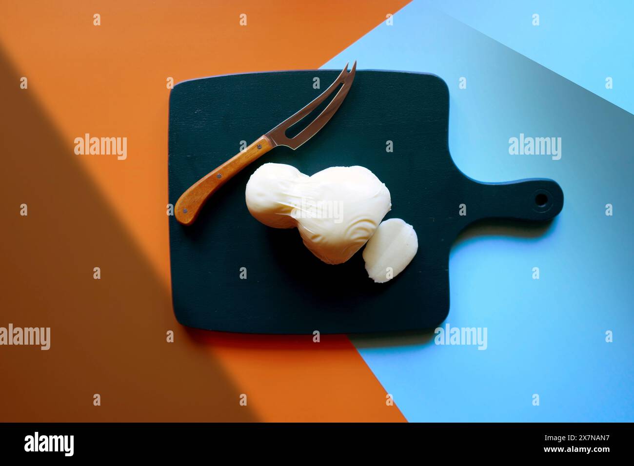 Mozzarella cheese on chopping board, with color blocking and geometric ...