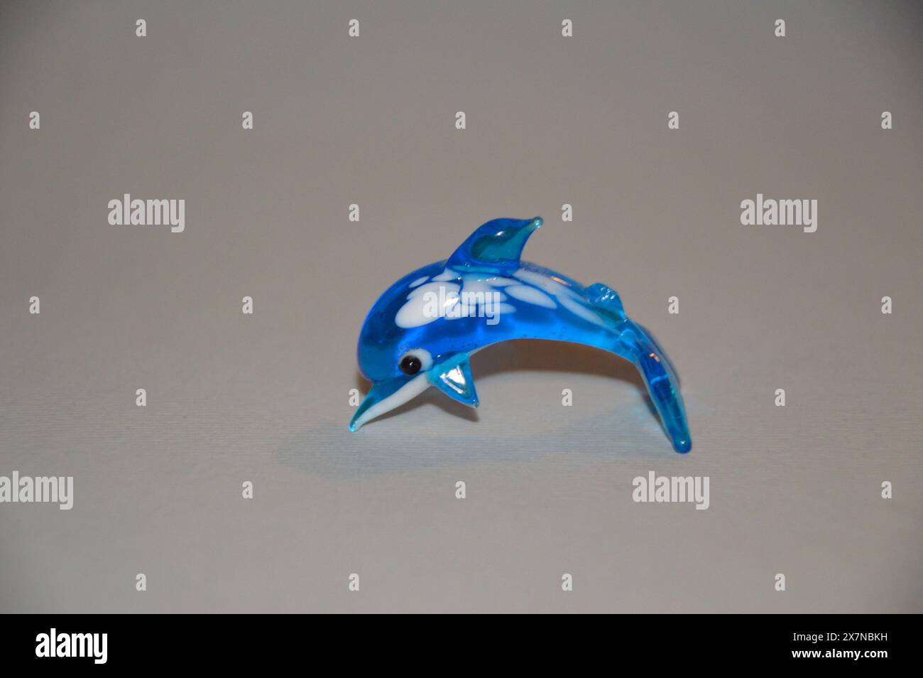 Blue glass dolphin Stock Photo - Alamy