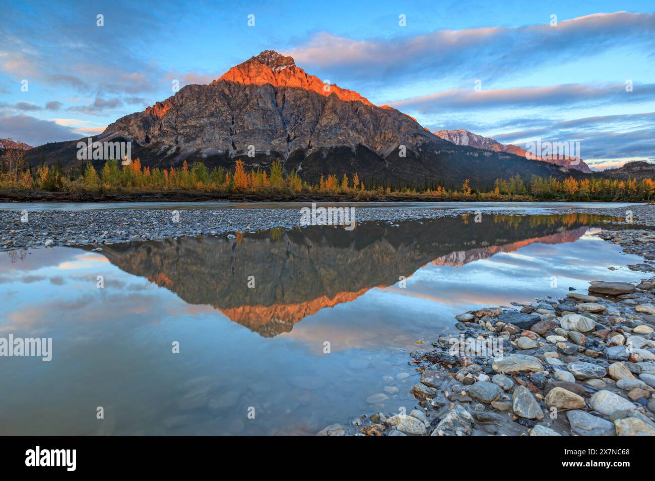 Evening light, reflection of steep mountain in water, Brooks Range, Dalton Highway, Alaska, USA ...