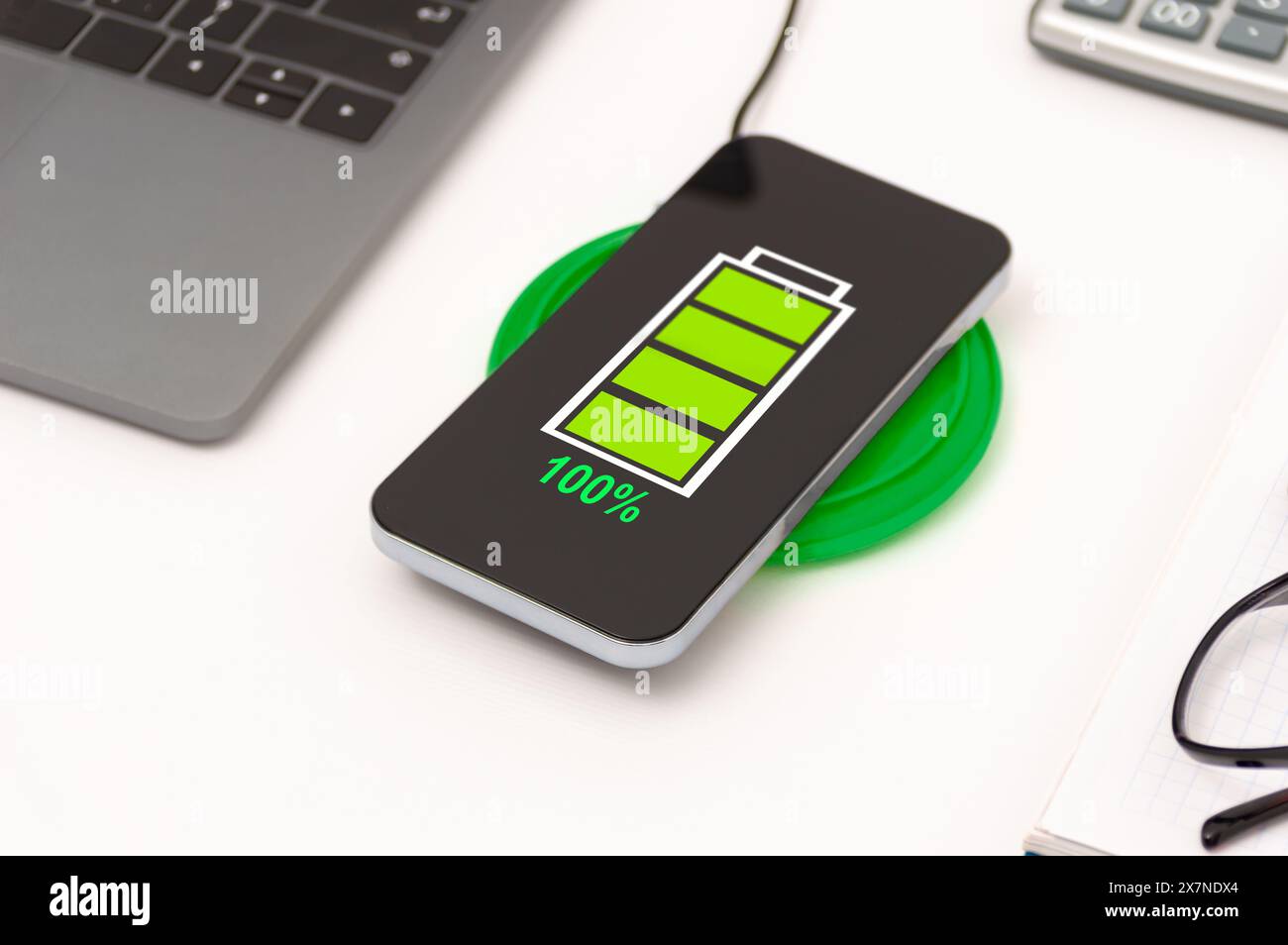 Close-up phone charging on wireless charger device at office Stock ...