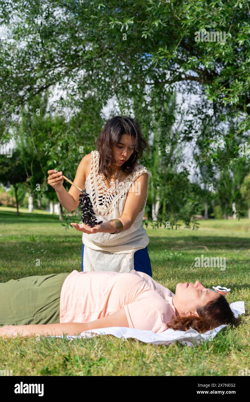 Colombian woman doing breathwork therapy to a woman outdoors Stock ...