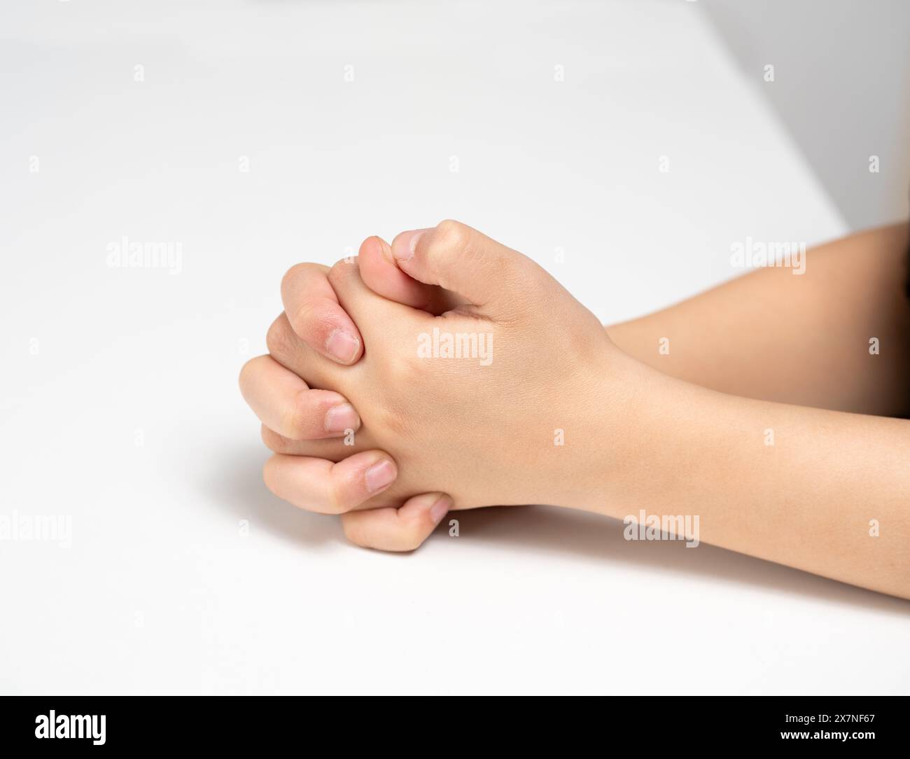 Hands of a nervous, anxious and worried child fidgeting with fingers ...