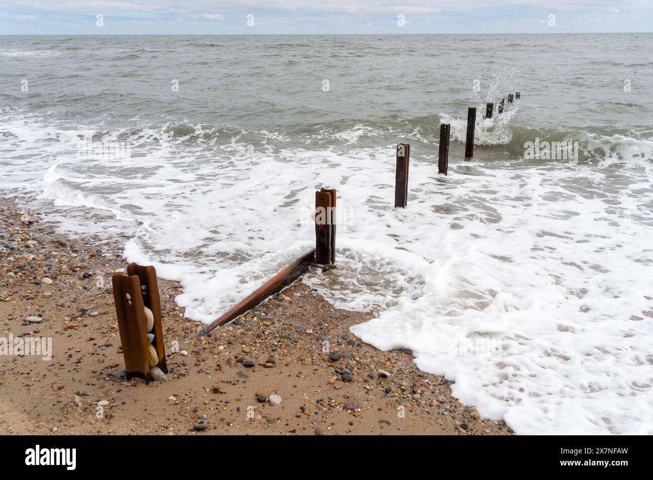 Old, decaying, rusty groyne in the sea, on Vane Tempest Beach in Seaham ...