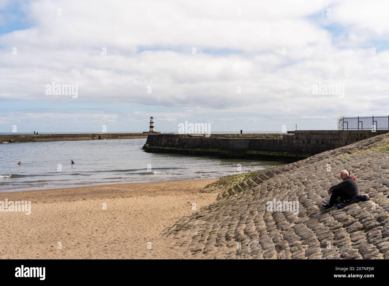 Seaham, County Durham, UK. A view of the lighthouse and harbour walls ...