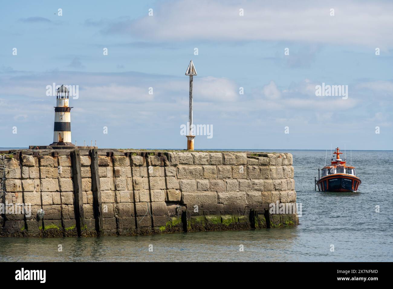 Seaham, County Durham, UK. A view of the lighthouse and harbour walls ...