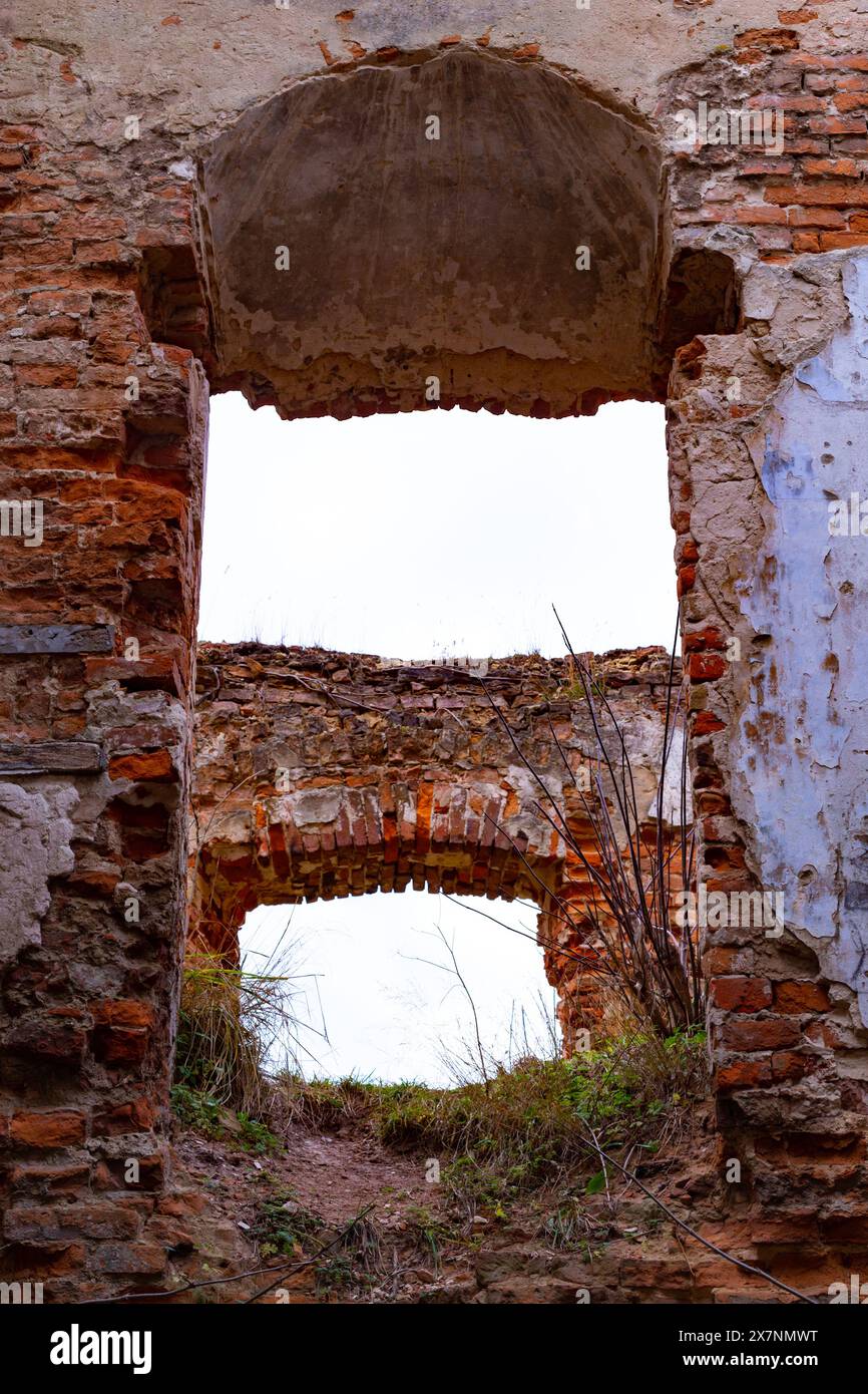 The old ruins of the collapsed walls with gates and windows ...