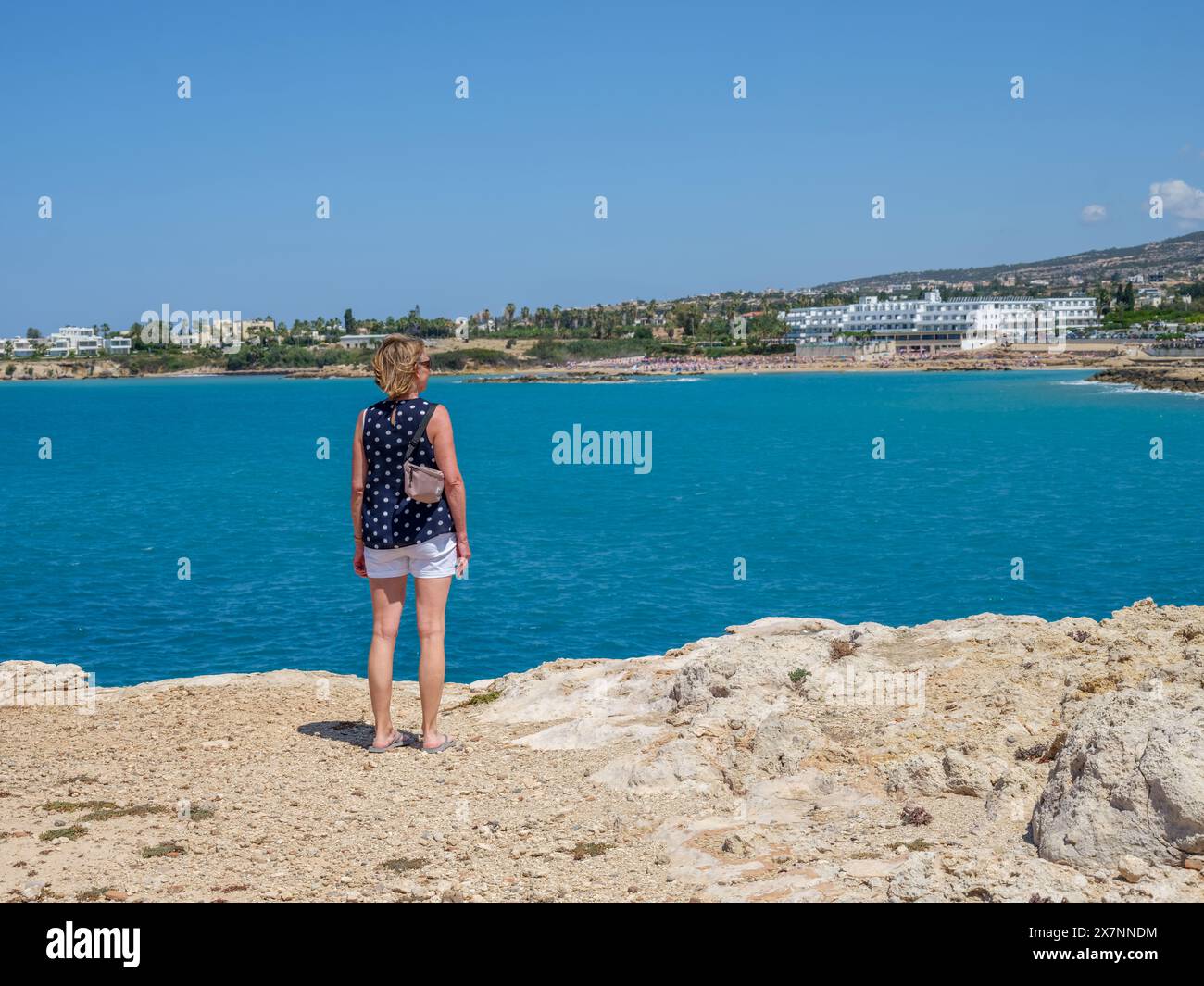 May 2024, Mature woman over looking the bay at Pegeia, Pafos, Cyprus ...