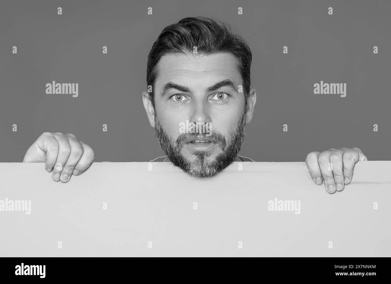 Man showing promo blank board on studio background. Blank signboard ...