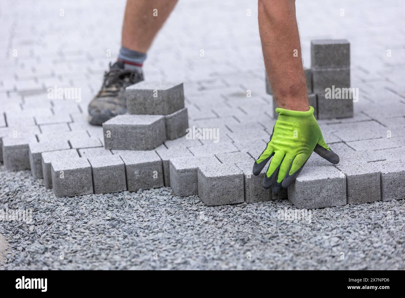 Process of building sidewalk, worker laying interlocking walking path ...
