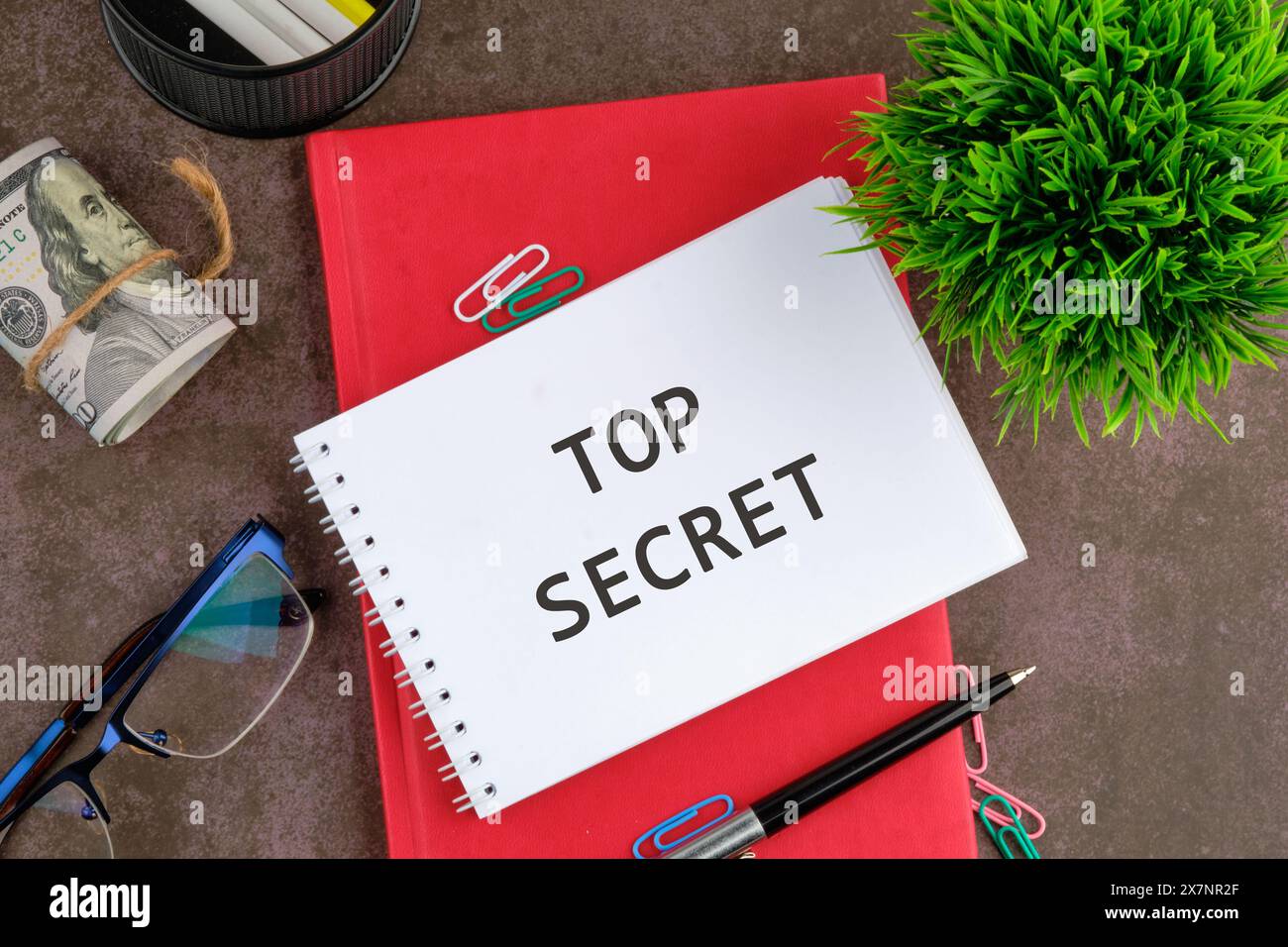 The sentence, Top Secret, written on a blank sheet of notepad next to ...