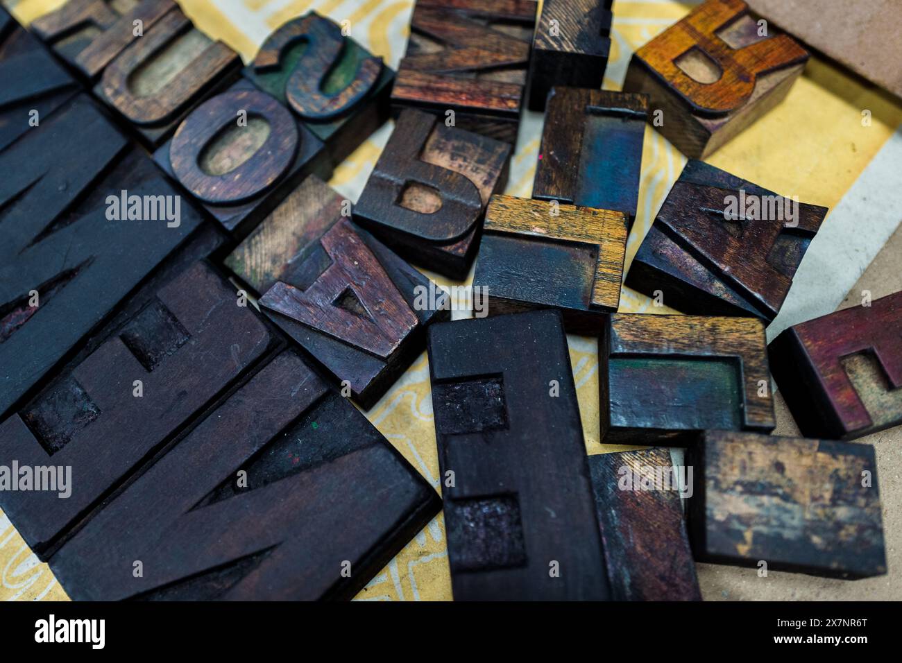 The movable letterpress types are seen randomly placed on the work ...