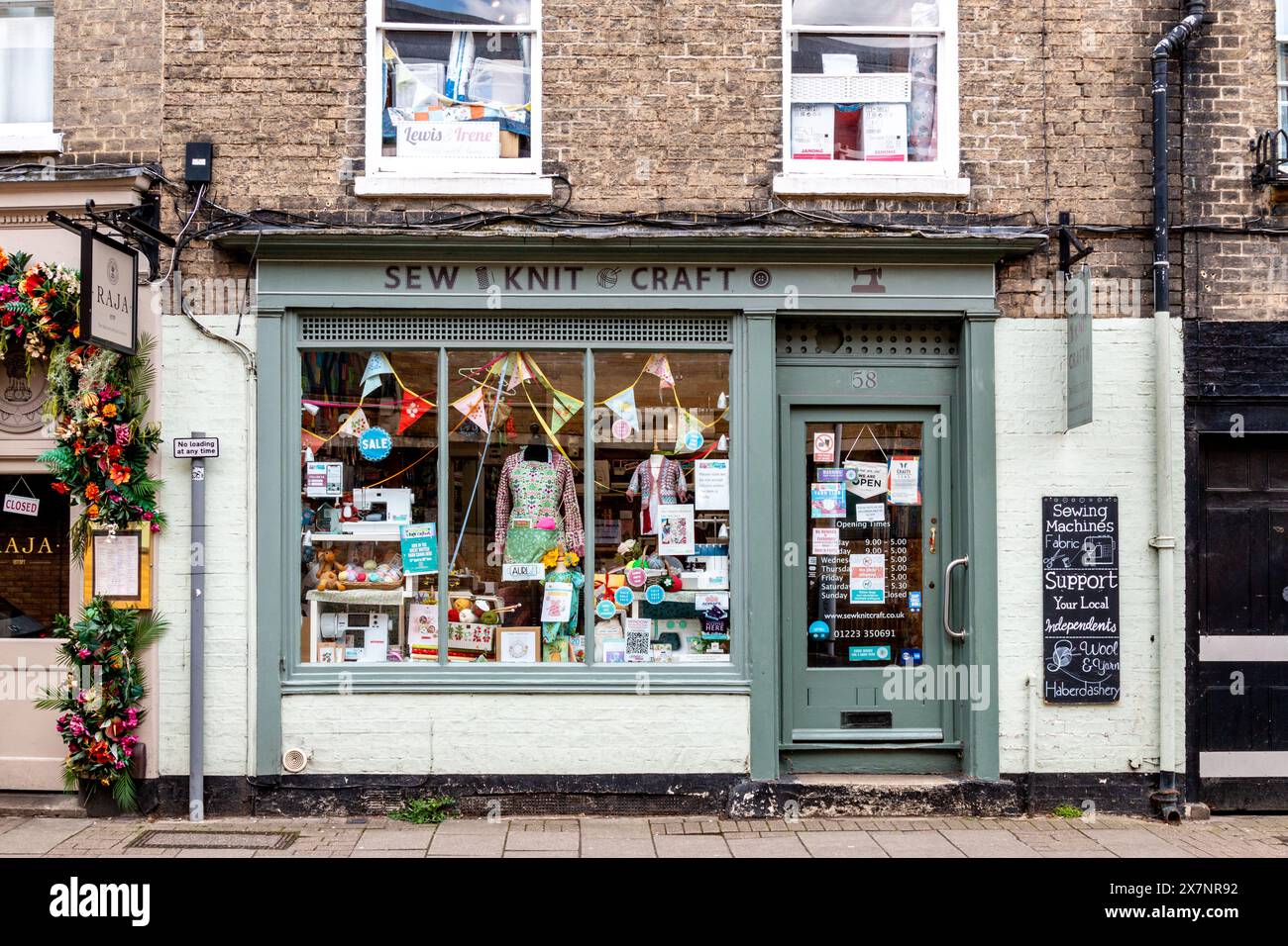 A charming storefront of a craft shop called 'Sew Knit Craft' featuring ...