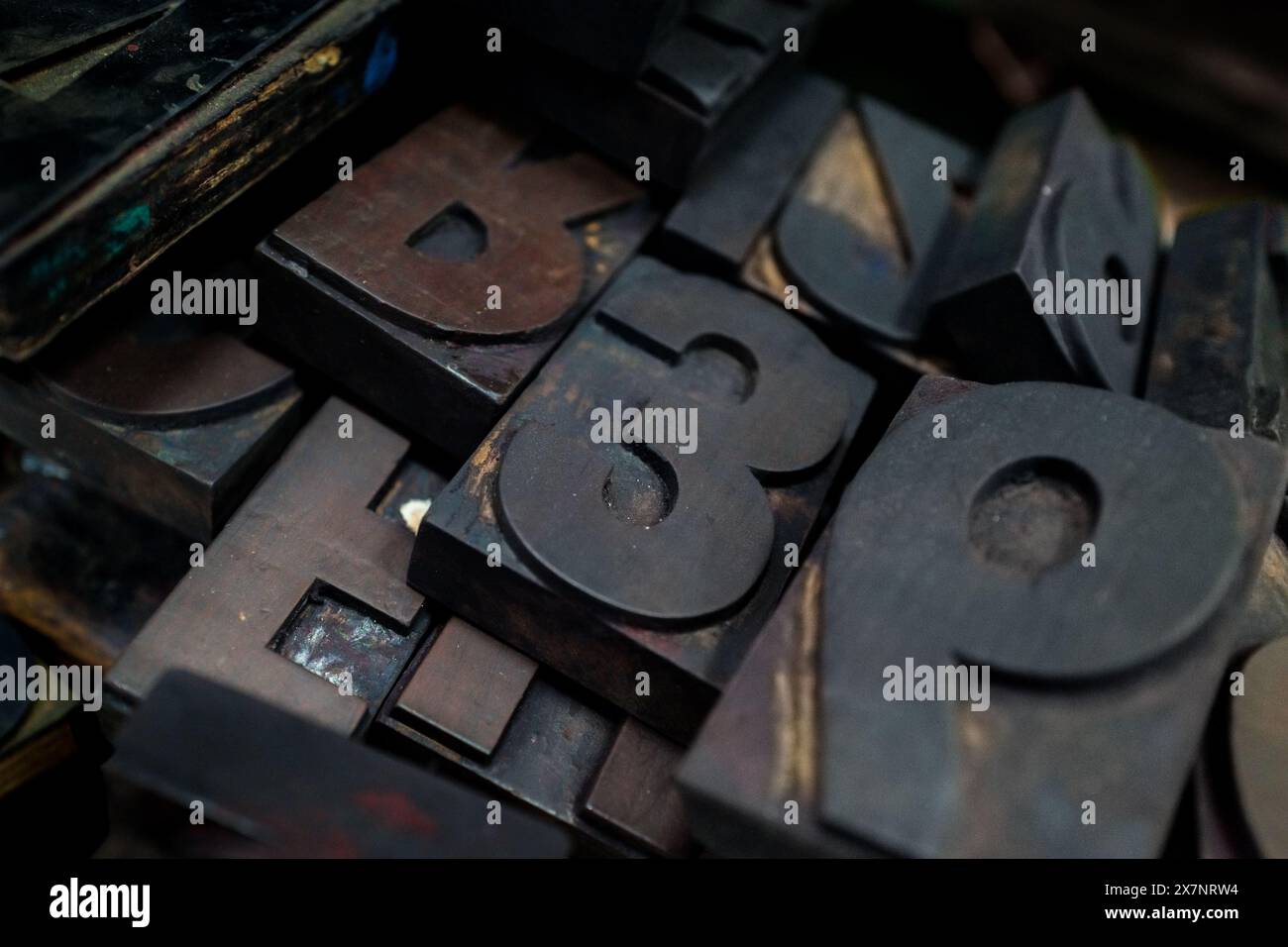 The movable wooden letterpress types are seen randomly stored in a tray ...