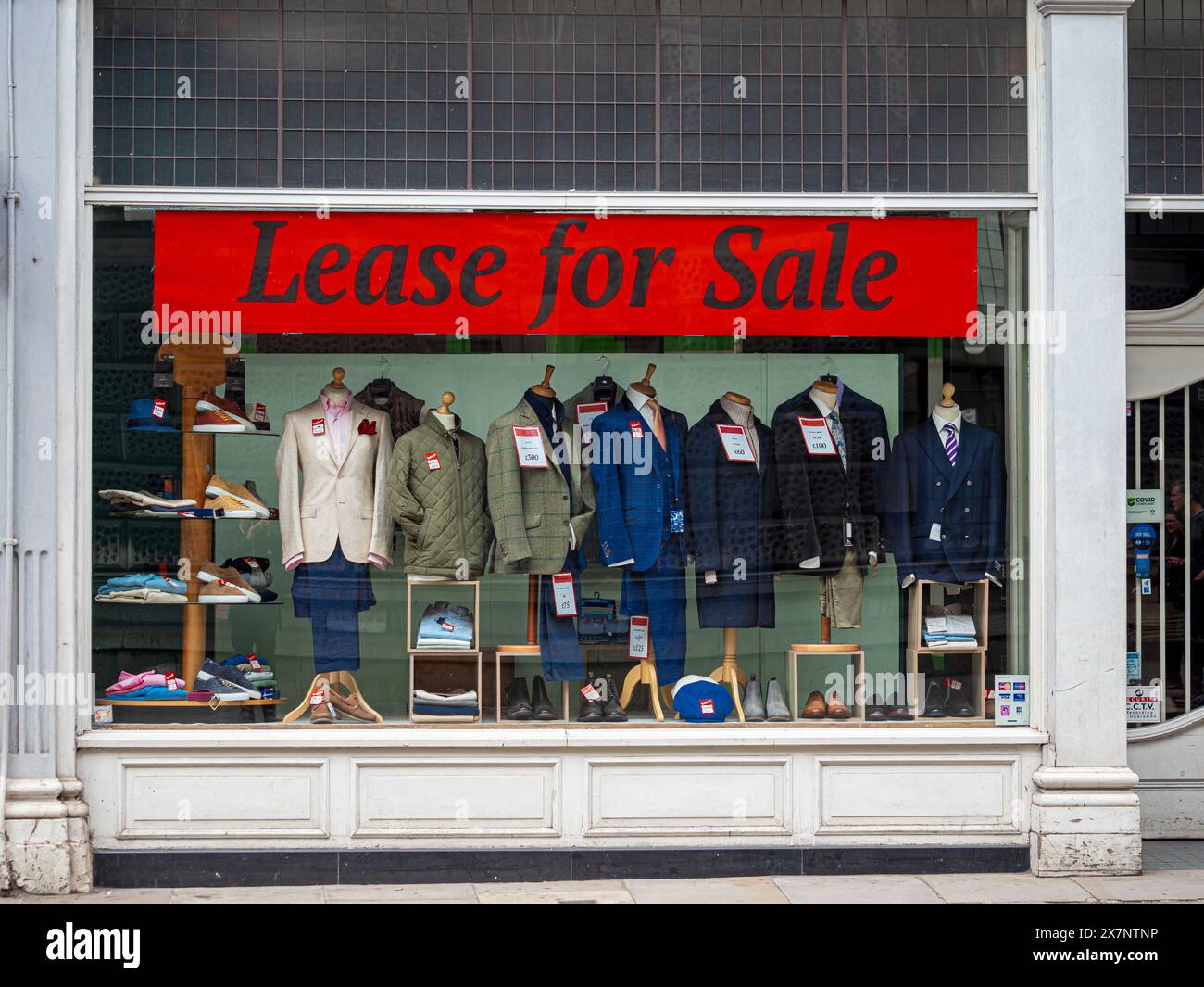 Lease for Sale banner sign in the window of a tailors shop in London ...