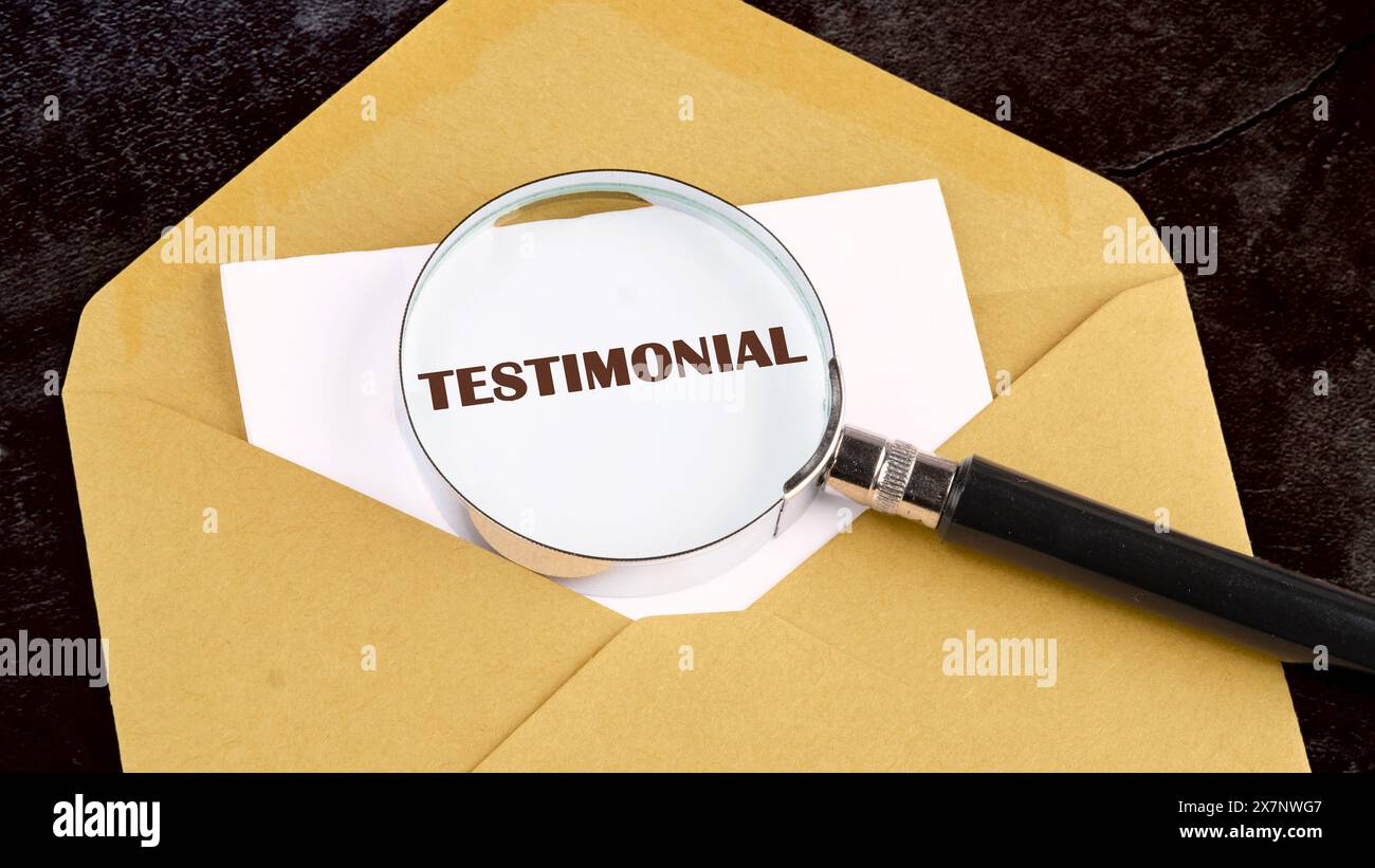 TESTIMONIAL written on a white sheet of paper through a magnifying ...