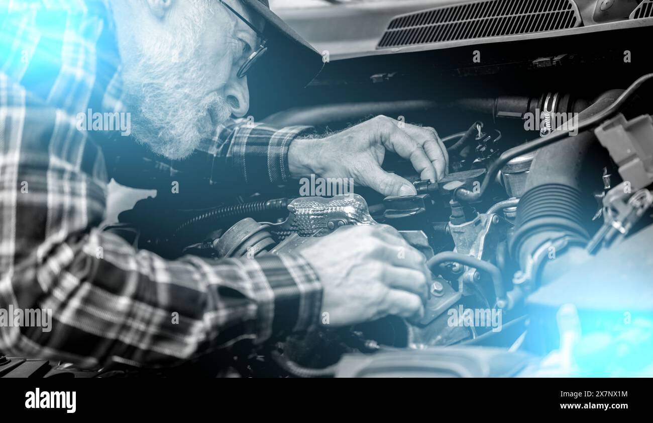 Car mechanic checking a car engine; light effect Stock Photo - Alamy