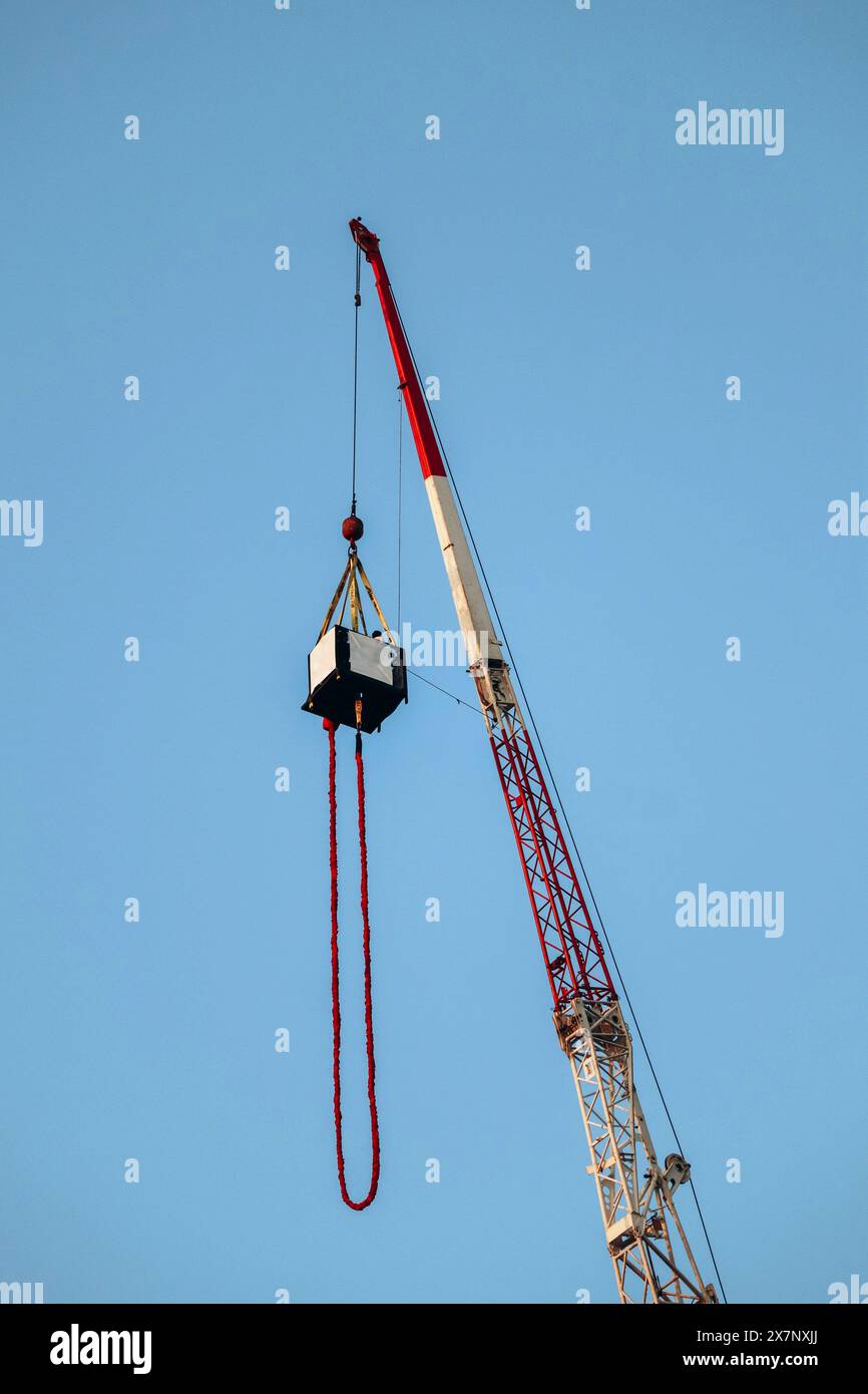 Bungee jumping from a great height while connected to a large elastic ...