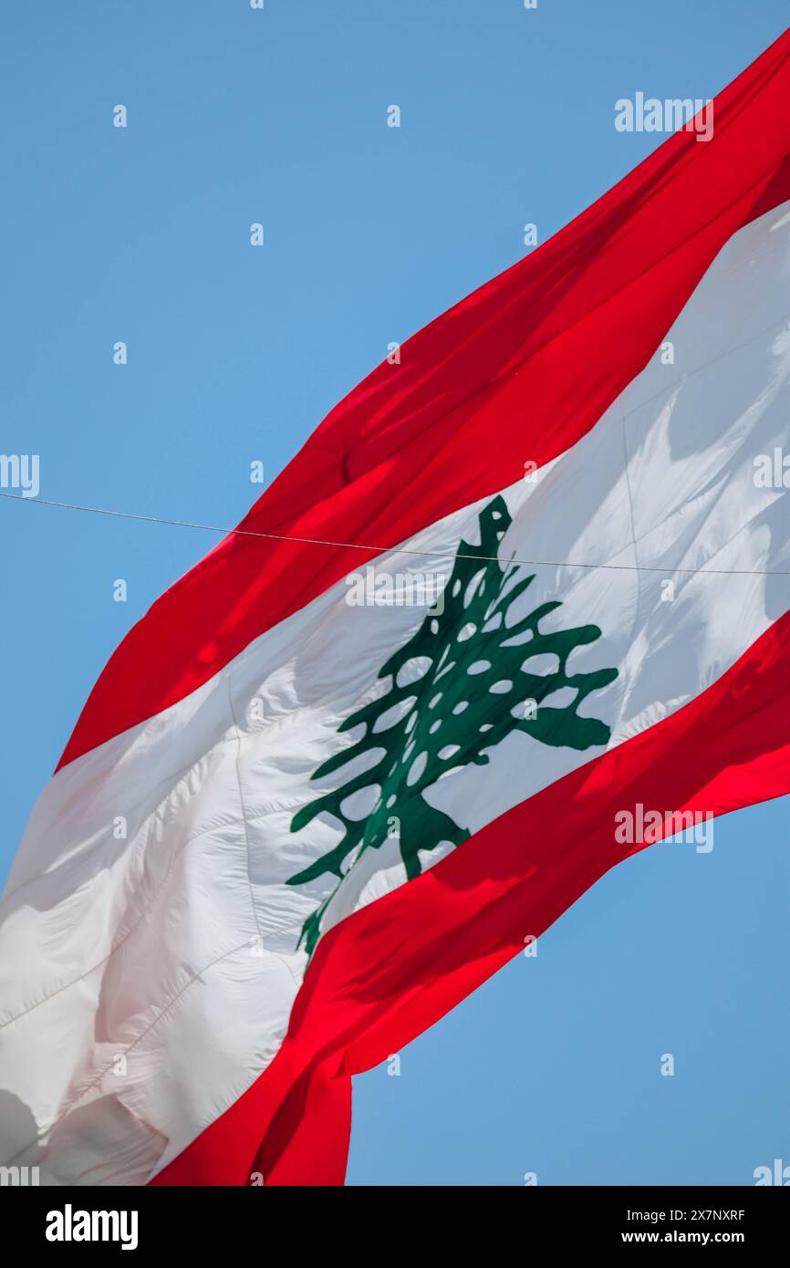 The Lebanese flag in the center of Beirut fluttering in the wind, close ...
