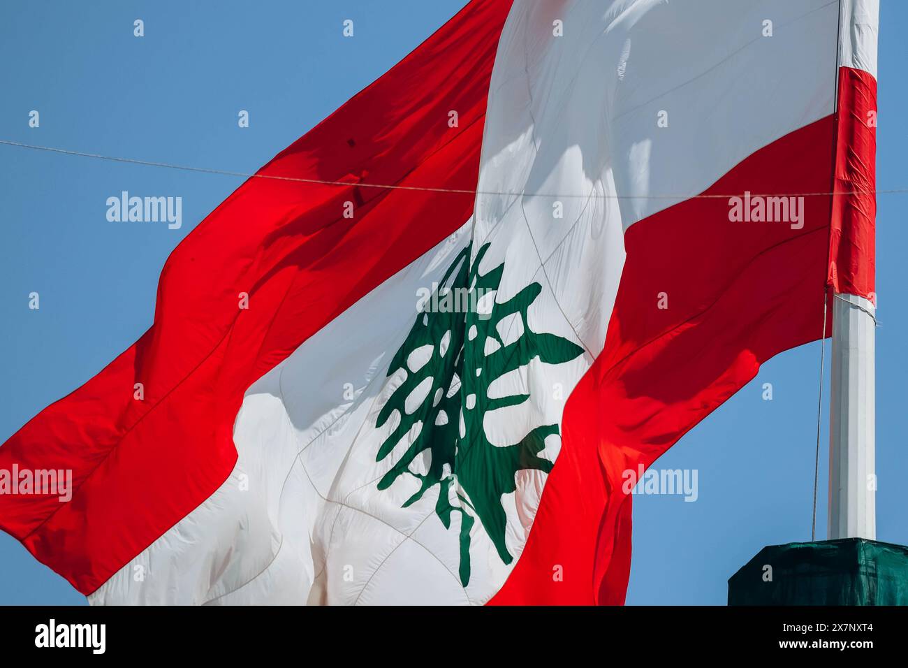 The Lebanese flag in the center of Beirut fluttering in the wind, close ...