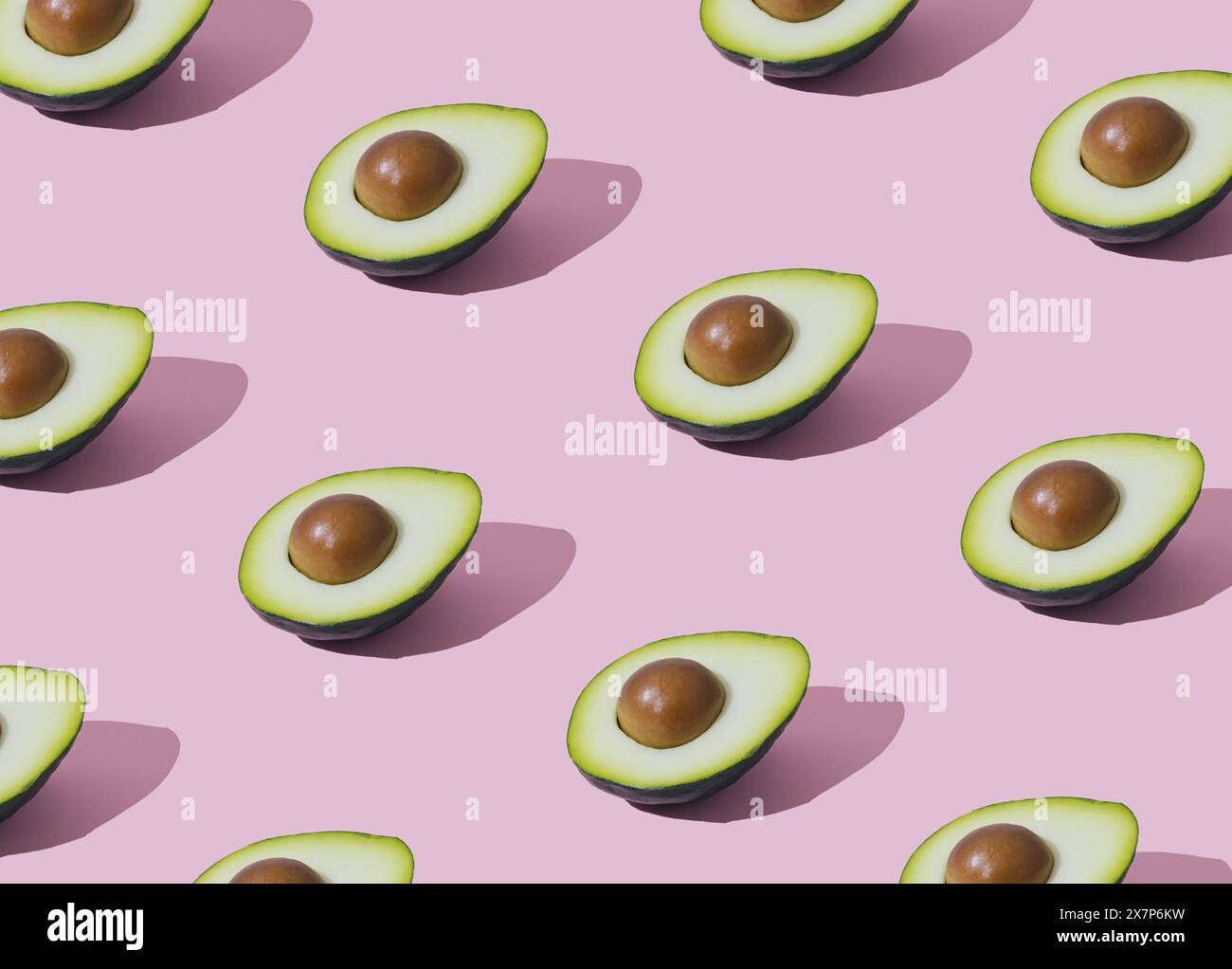 Trendy fruit pattern made of avocado on light pastel pink background ...