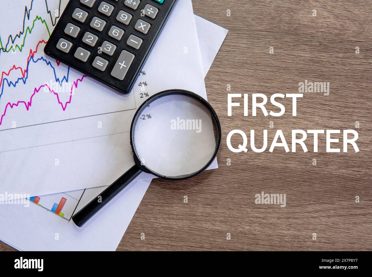 Top view image text FIRST QUARTER on office desk. First quarter concept ...