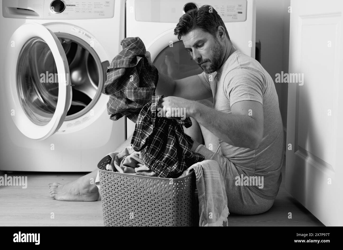Man washing clothes doing laundry Black and White Stock Photos & Images - Alamy