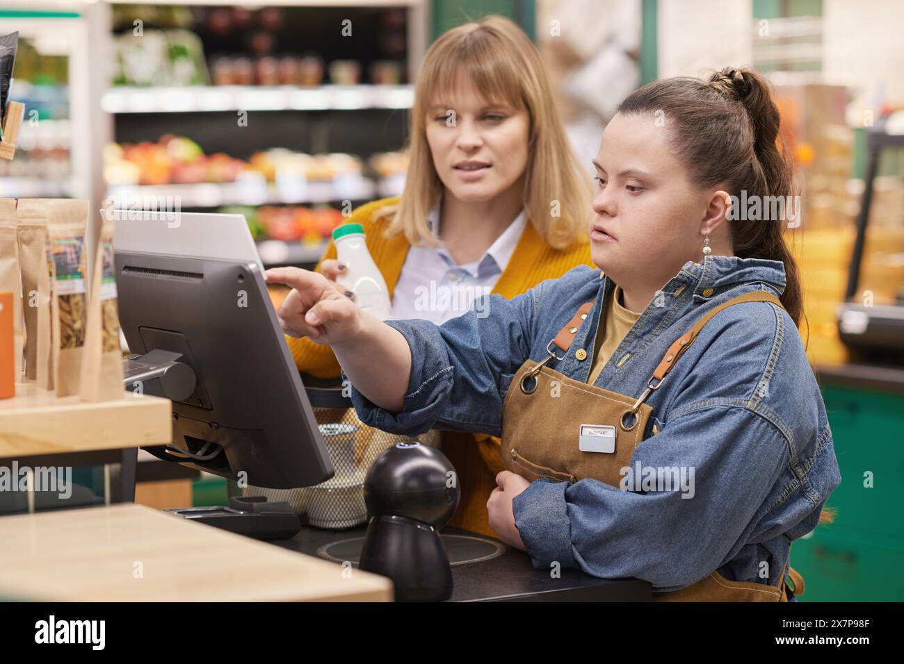 Portrait of young woman with Down syndrome learning to use cash ...
