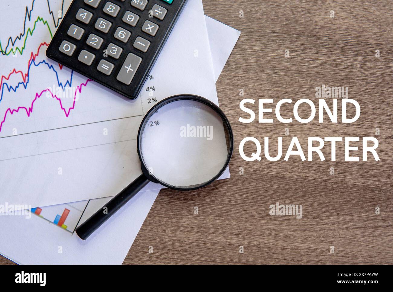 Top view image of text SECOND QUARTER on office desk. Second quarter ...