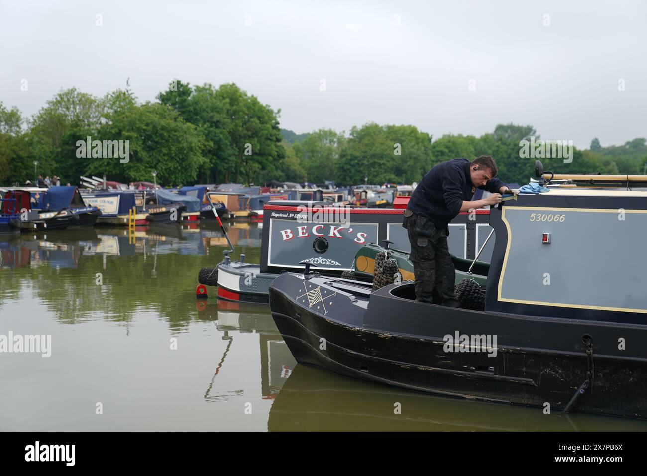A man adds some finishing touches to a canal boat, at Crick Marina in ...