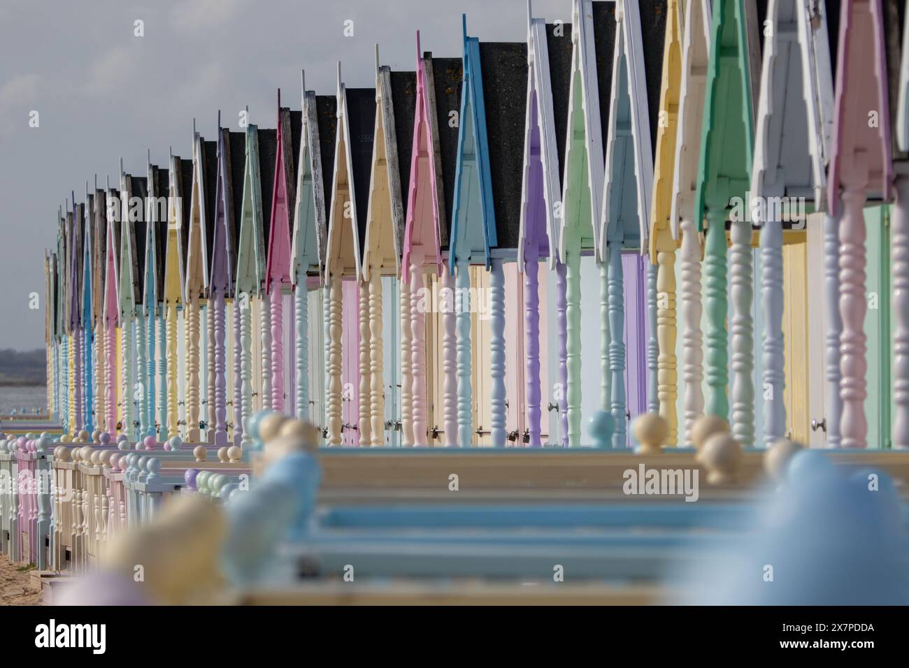 Pretty coloured beach huts on West Mersea beach in Essex UK Stock Photo ...