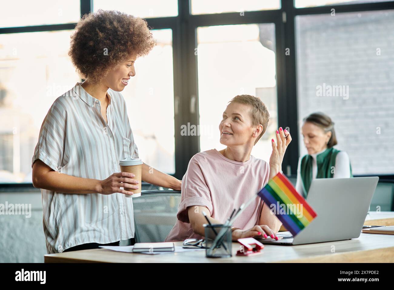 Cheerful diverse businesswomen working together on project in office ...