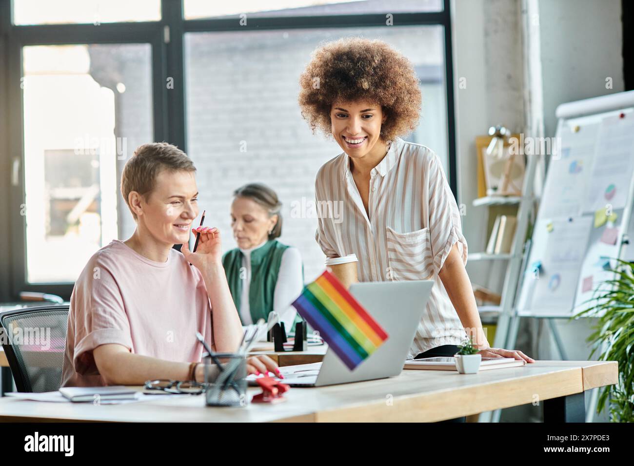 Attractive diverse businesswomen working together on project in office ...