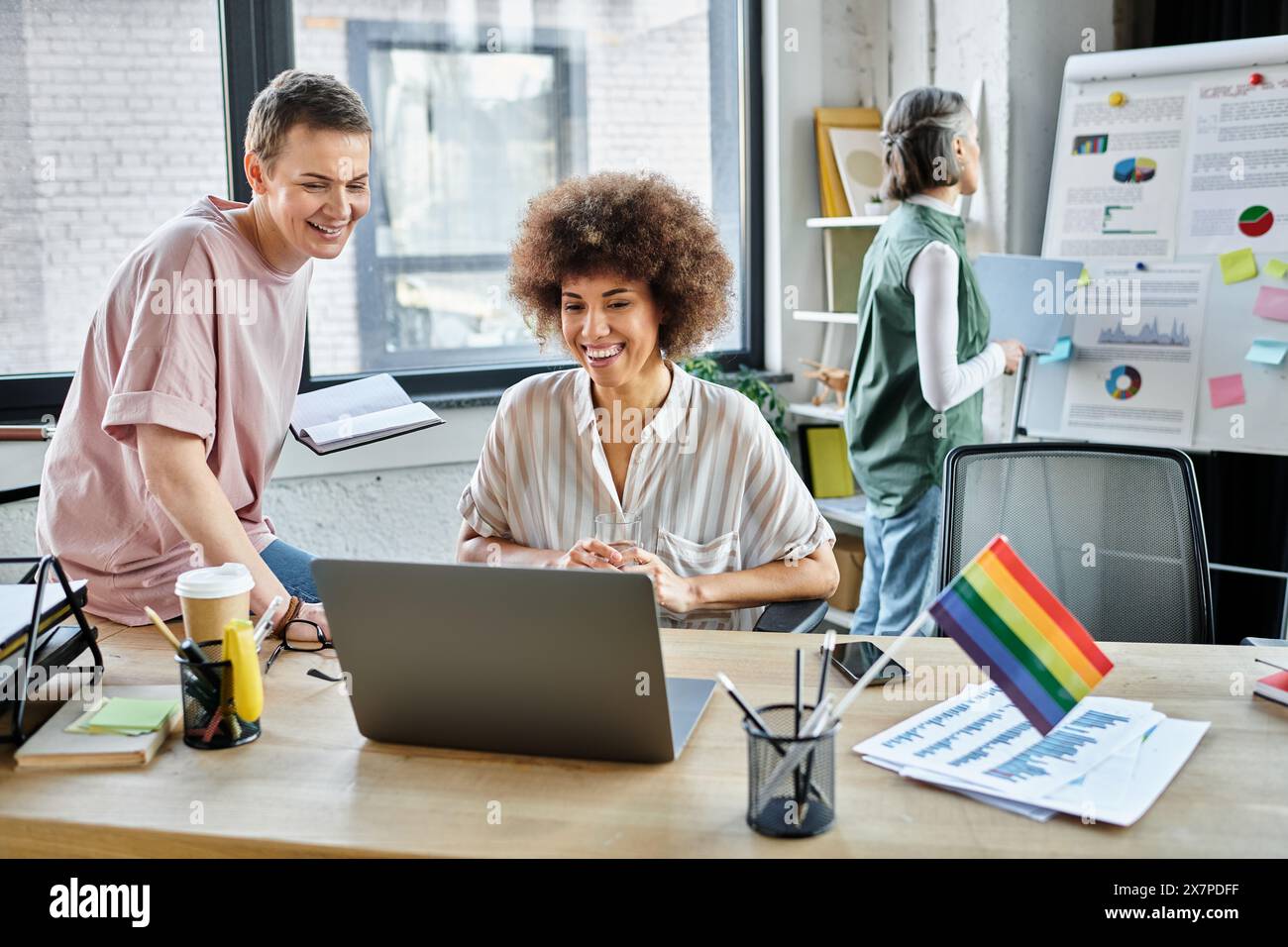 Attractive diverse female professionals working together on their ...