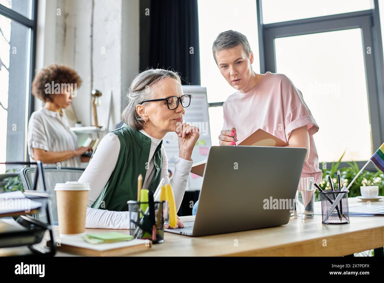 Concentrated diverse female professionals working together on their ...
