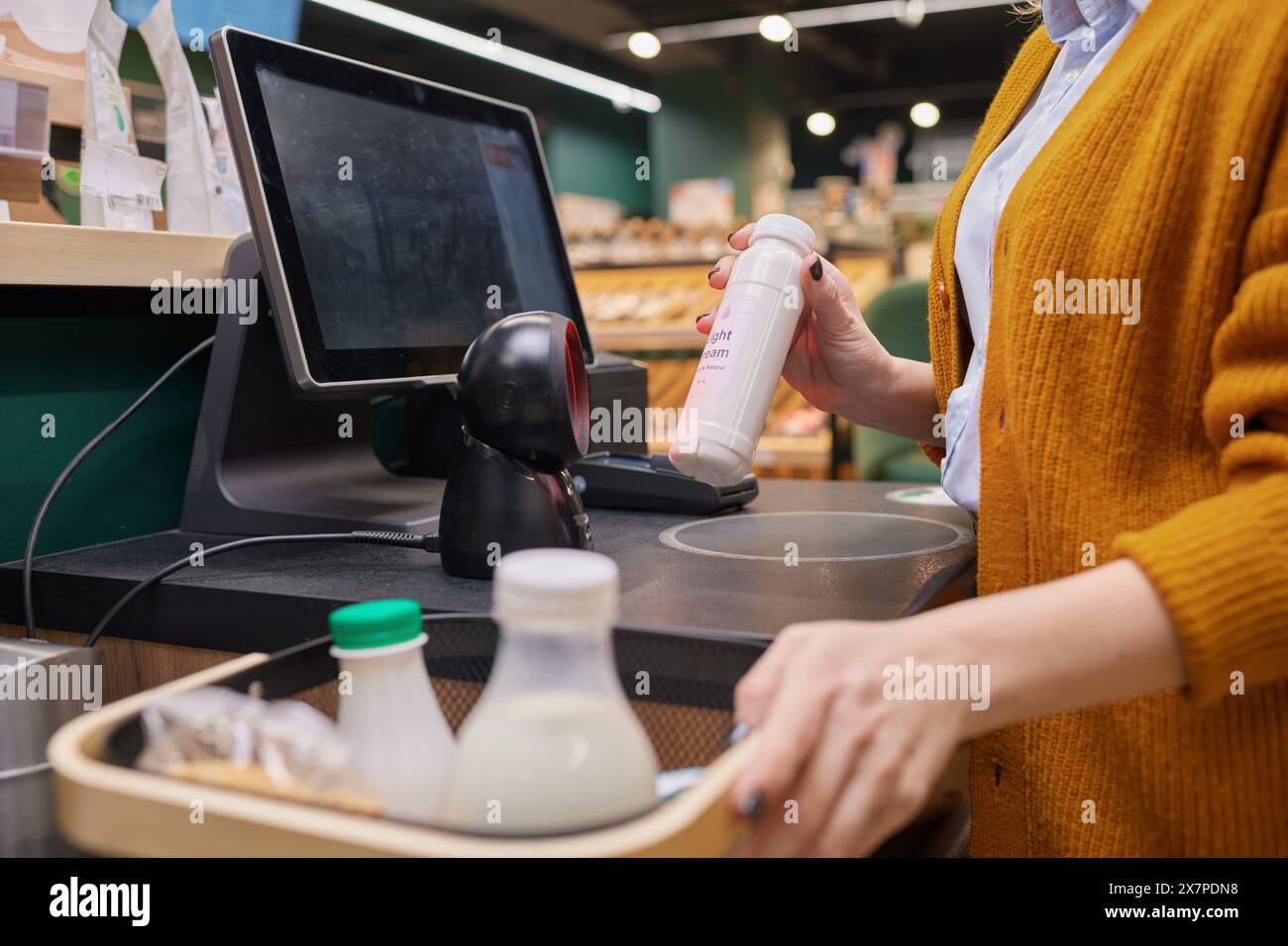 Close up of unrecognizable woman using self checkout in supermarket and ...