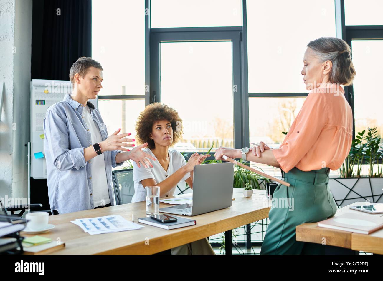 A group of hard-working, diverse businesswomen are gathered around a ... A group of hard-working, diverse businesswomen are gathered around a ...