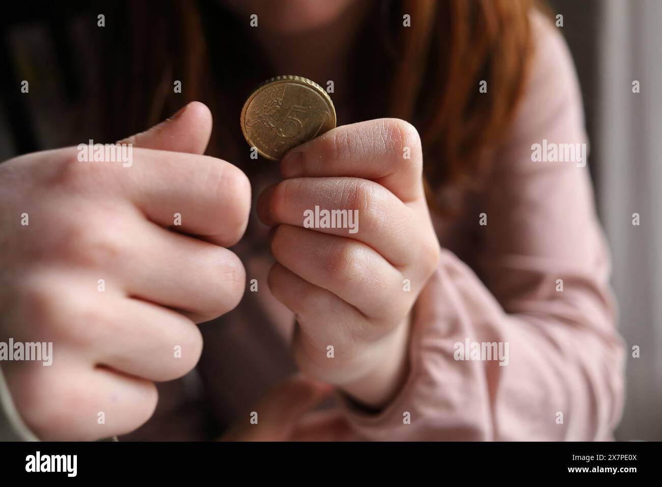 Girl sharing coin with her brother. Financial education concept. Close ...