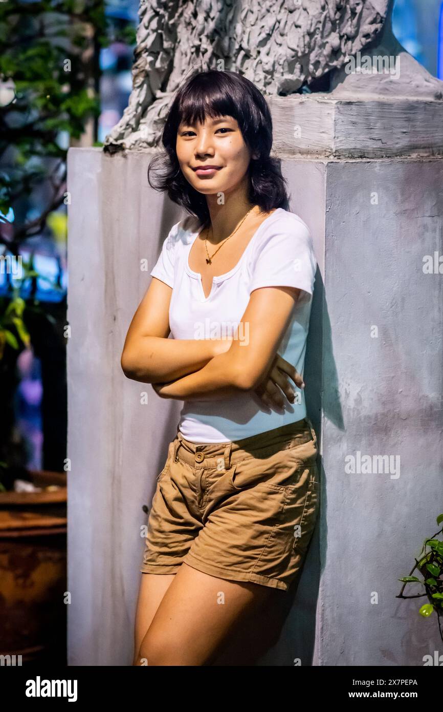 A pretty young filipino girl stands outside Santo Nino de Tondo Church ...