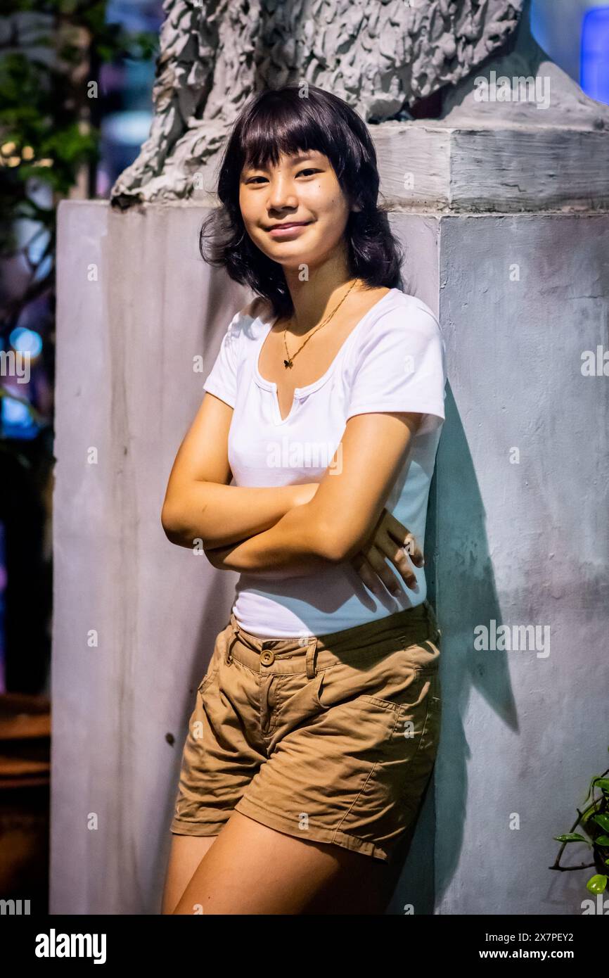 A pretty young filipino girl stands outside Santo Nino de Tondo Church ...