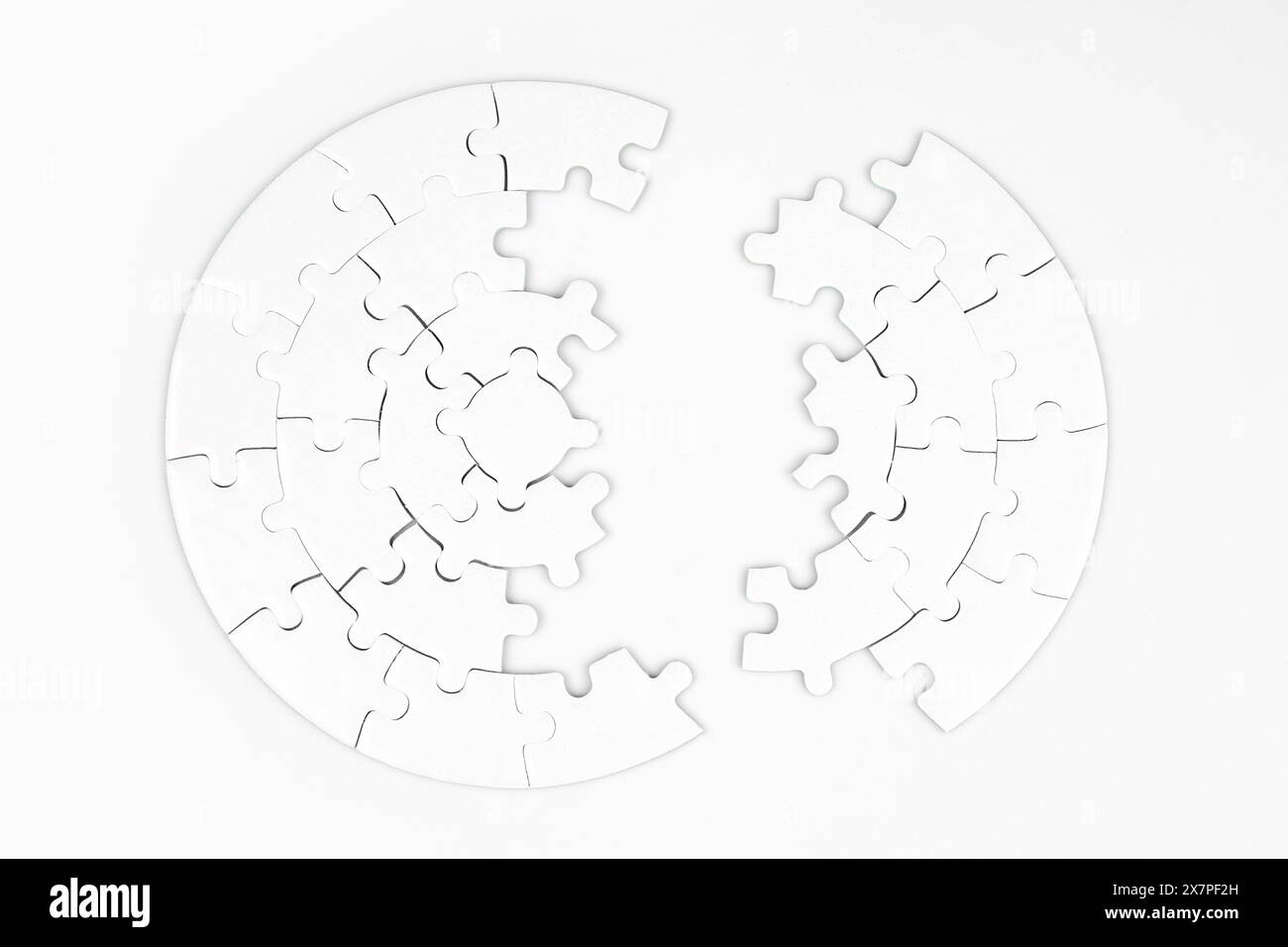 Close-up top view of a blank circular jigsaw puzzle split into two ...