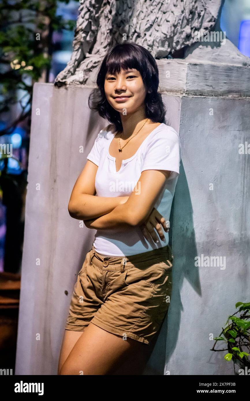 A pretty young filipino girl stands outside Santo Nino de Tondo Church ...