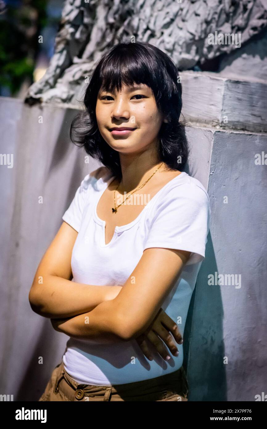 A pretty young filipino girl stands outside Santo Nino de Tondo Church ...