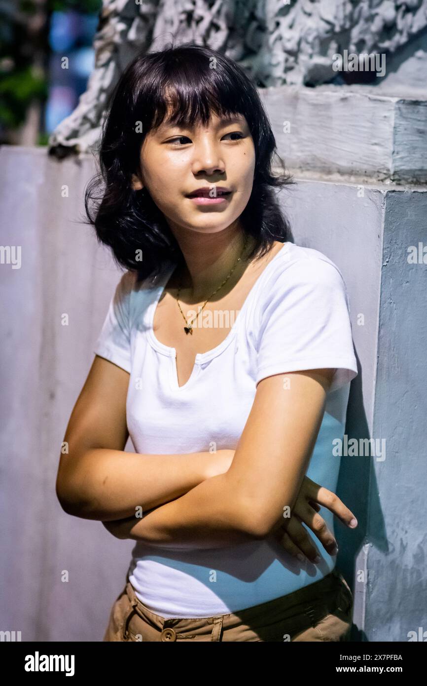 A pretty young filipino girl stands outside Santo Nino de Tondo Church ...