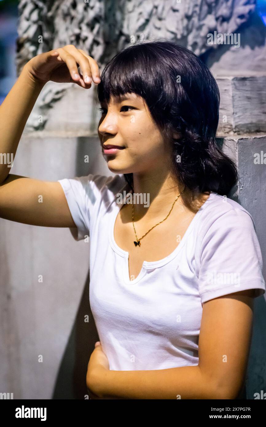 A pretty young filipino girl stands outside Santo Nino de Tondo Church ...