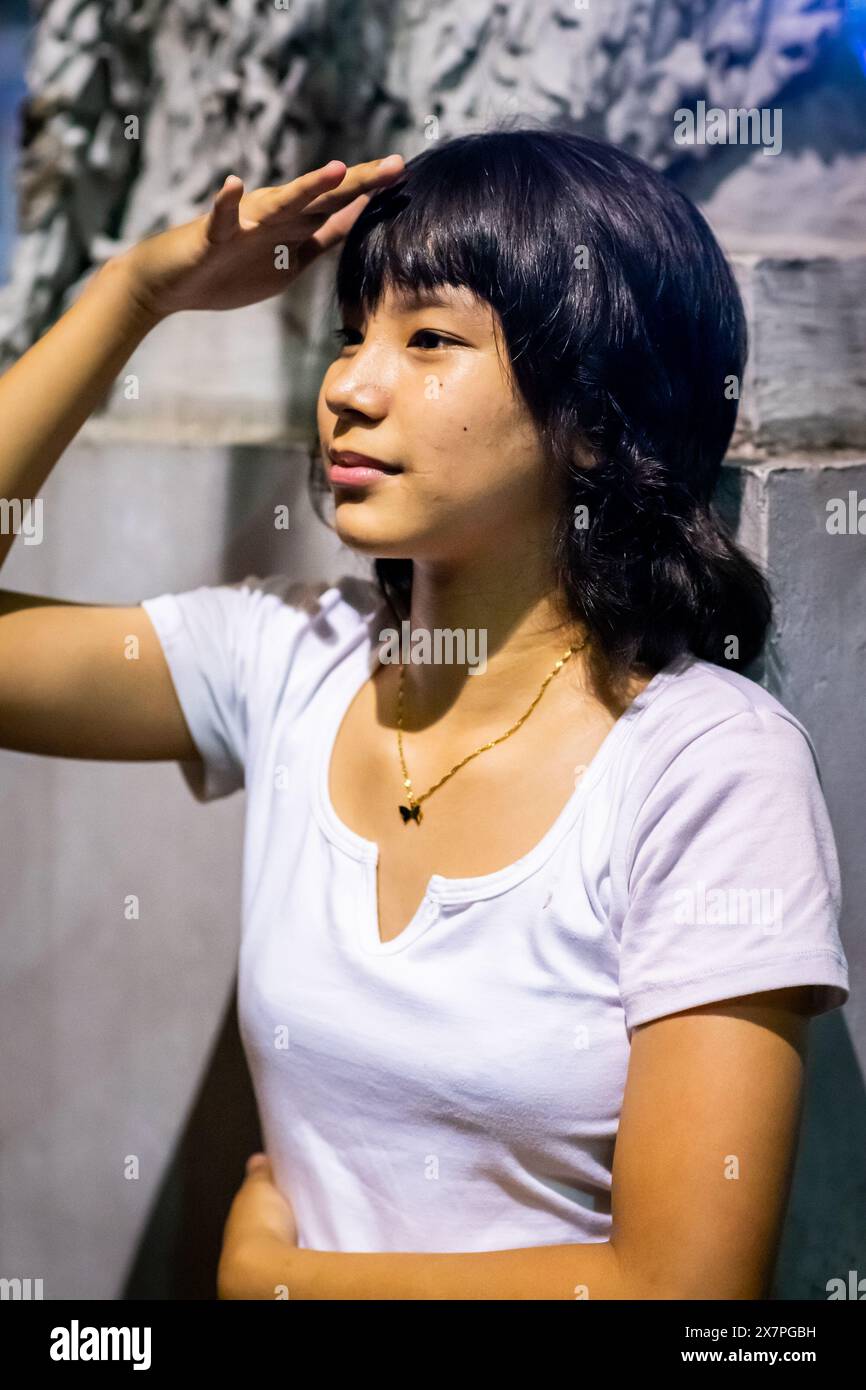 A pretty young filipino girl stands outside Santo Nino de Tondo Church ...