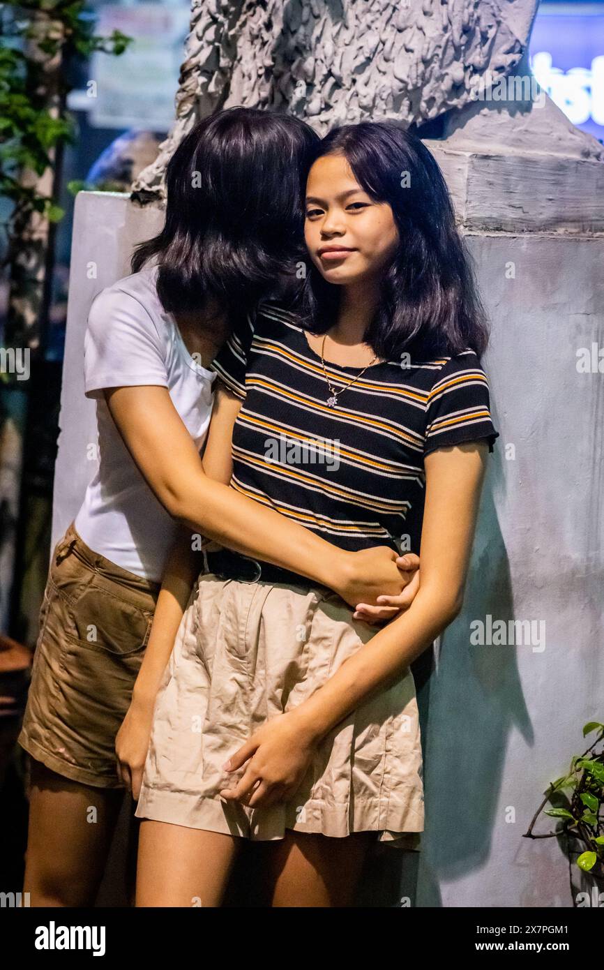 Two young filipino girlfriends hug outside Santo Nino de Tondo Church ...