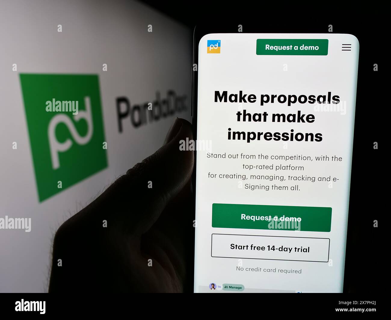Person holding cellphone with webpage of US document automation ...