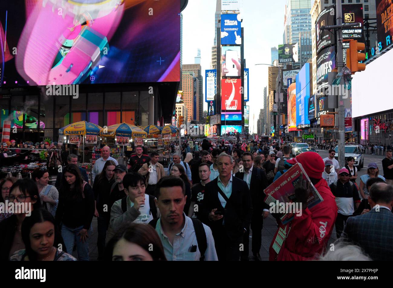 Pedestrians walk through Times Square, New York City. (Photo by Jimin ...